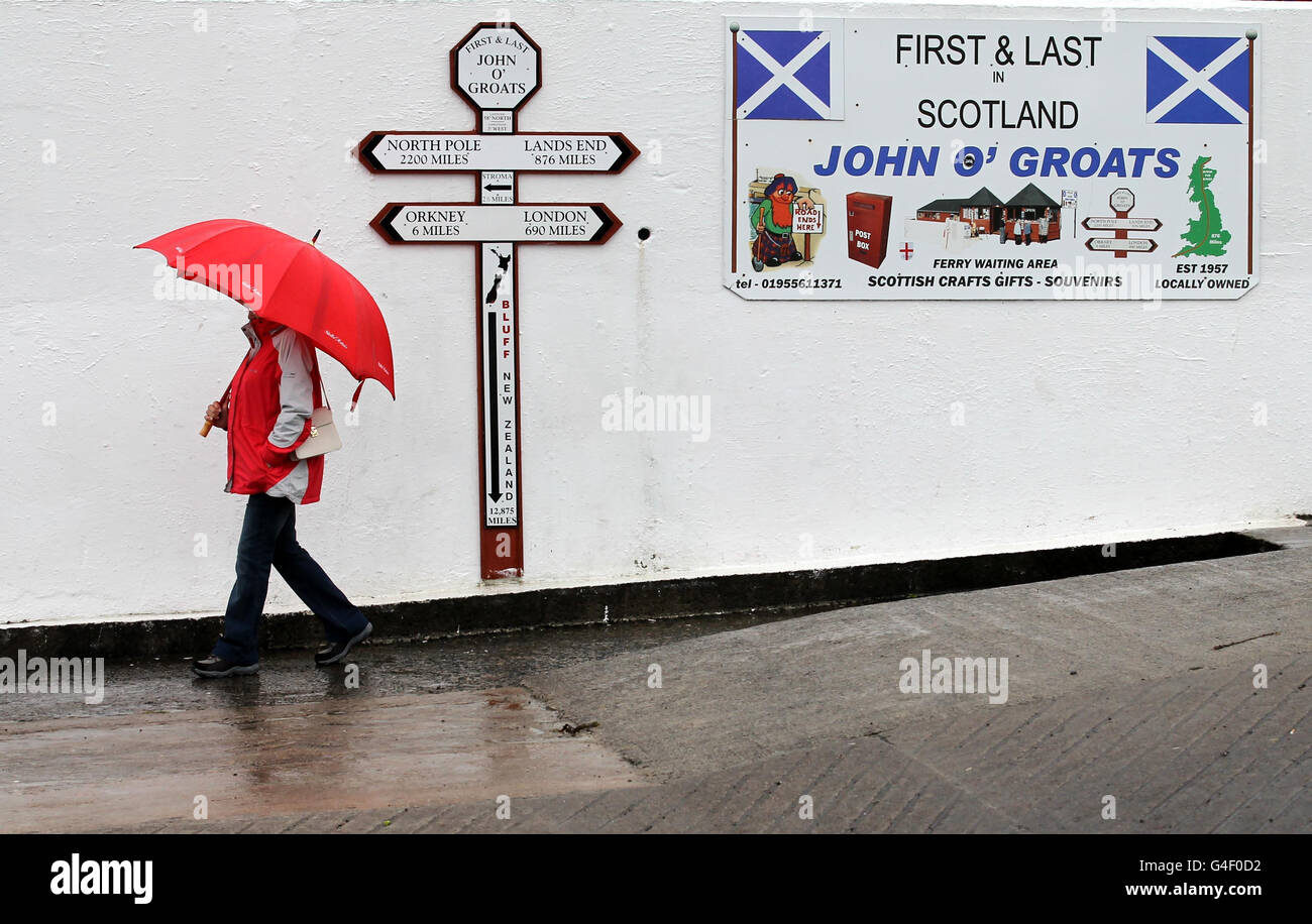 Summer weather August 7. A pedestrian shelters under an umbrella at ...