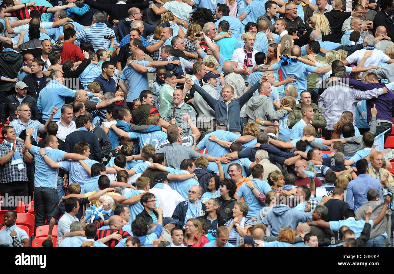 Manchester city fans do the poznan celebration in the stands hi-res ...
