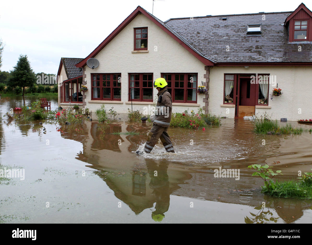 A fireman at Jayvana Lodge in Inchmore near Inverness, trying to keep ...