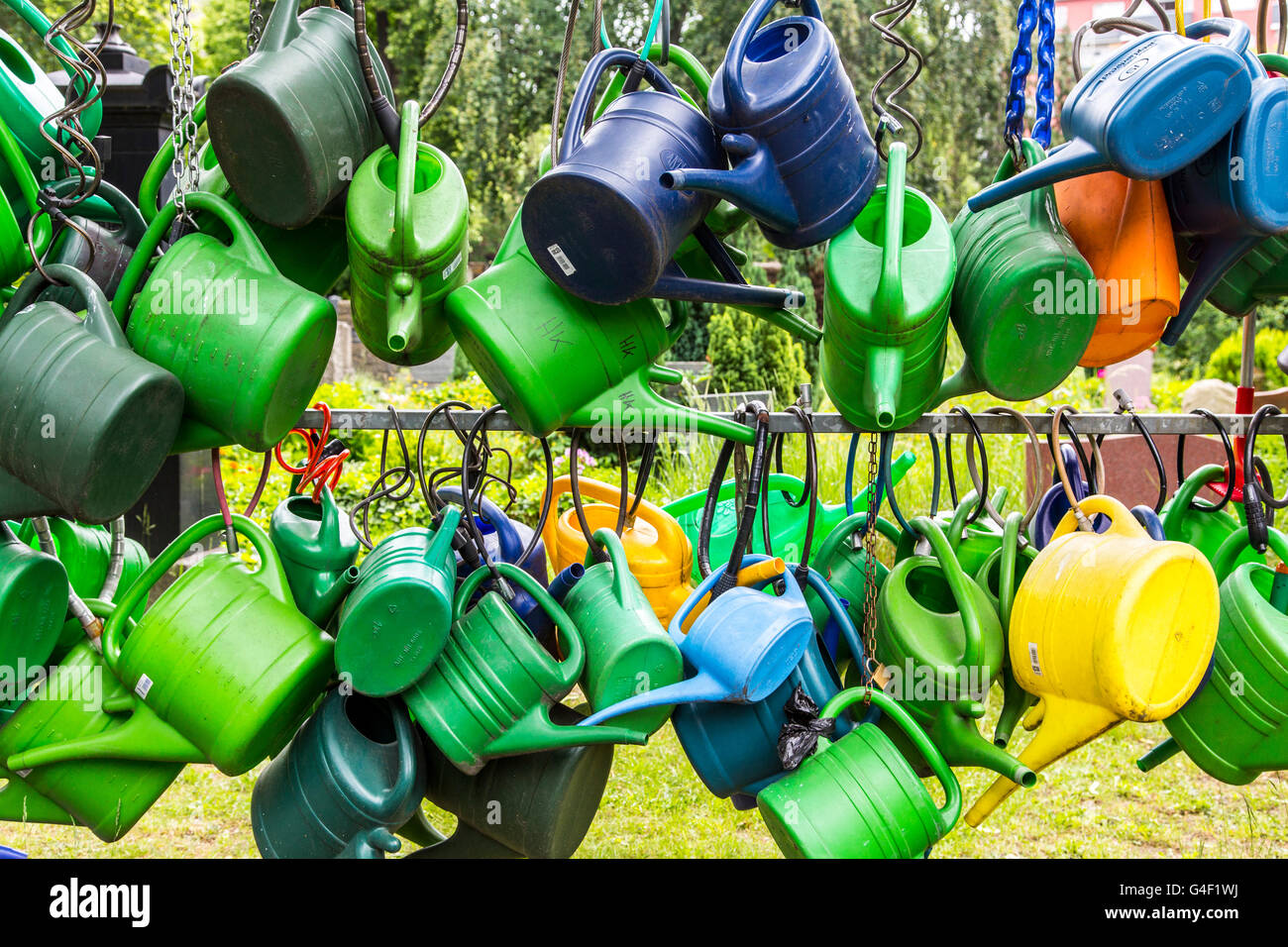 Many colorful watering cans hi-res stock photography and images - Alamy
