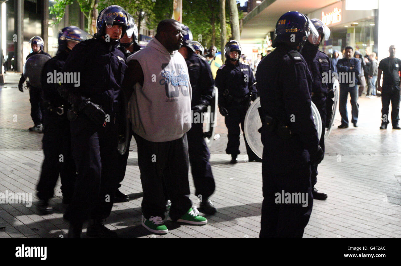 Police pictured escorting a man near the Bullring shopping centre in ...