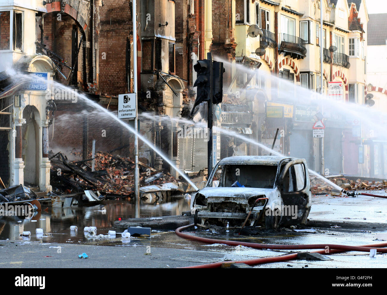 Fire crews douse burnt out buildings on London Road in Croydon, Surrey ...