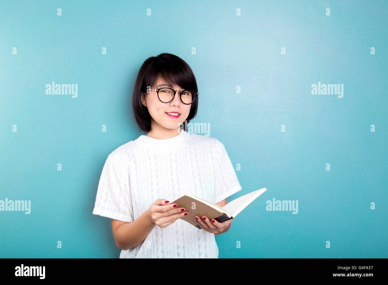 Young asian women thinking on blue background Stock Photo - Alamy