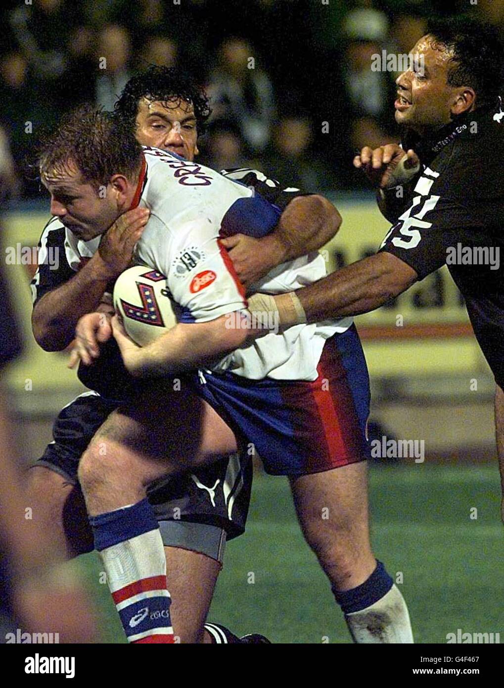 Britain's Terry O Connor is stopped by New Zealand's Kevin Iro and Tony ...