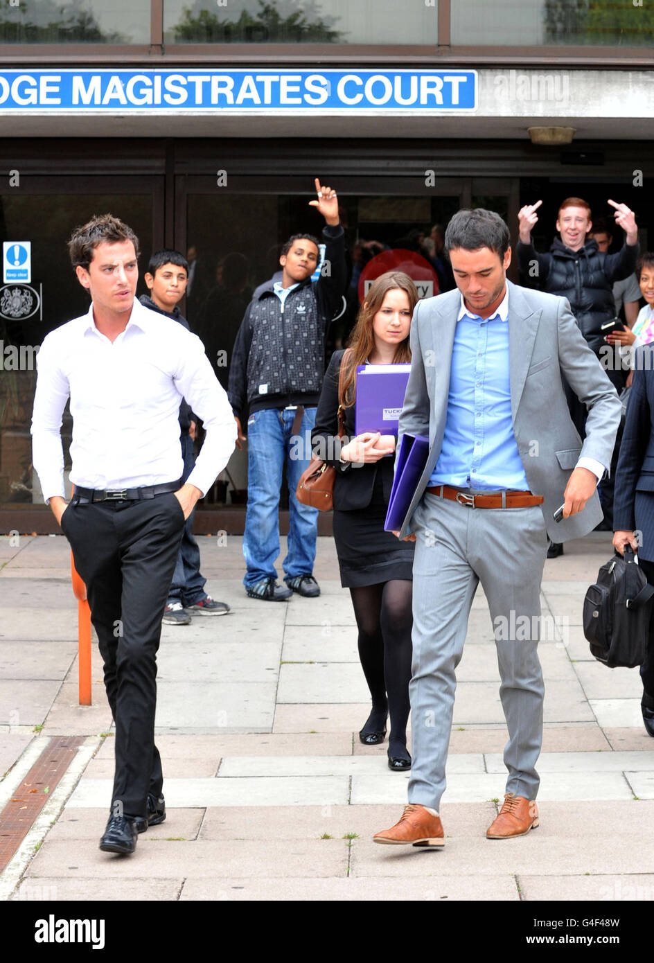 EDITORS NOTE GESTURES IN BACKGROUND. Jack (right) and Lewis Tweed leave ...
