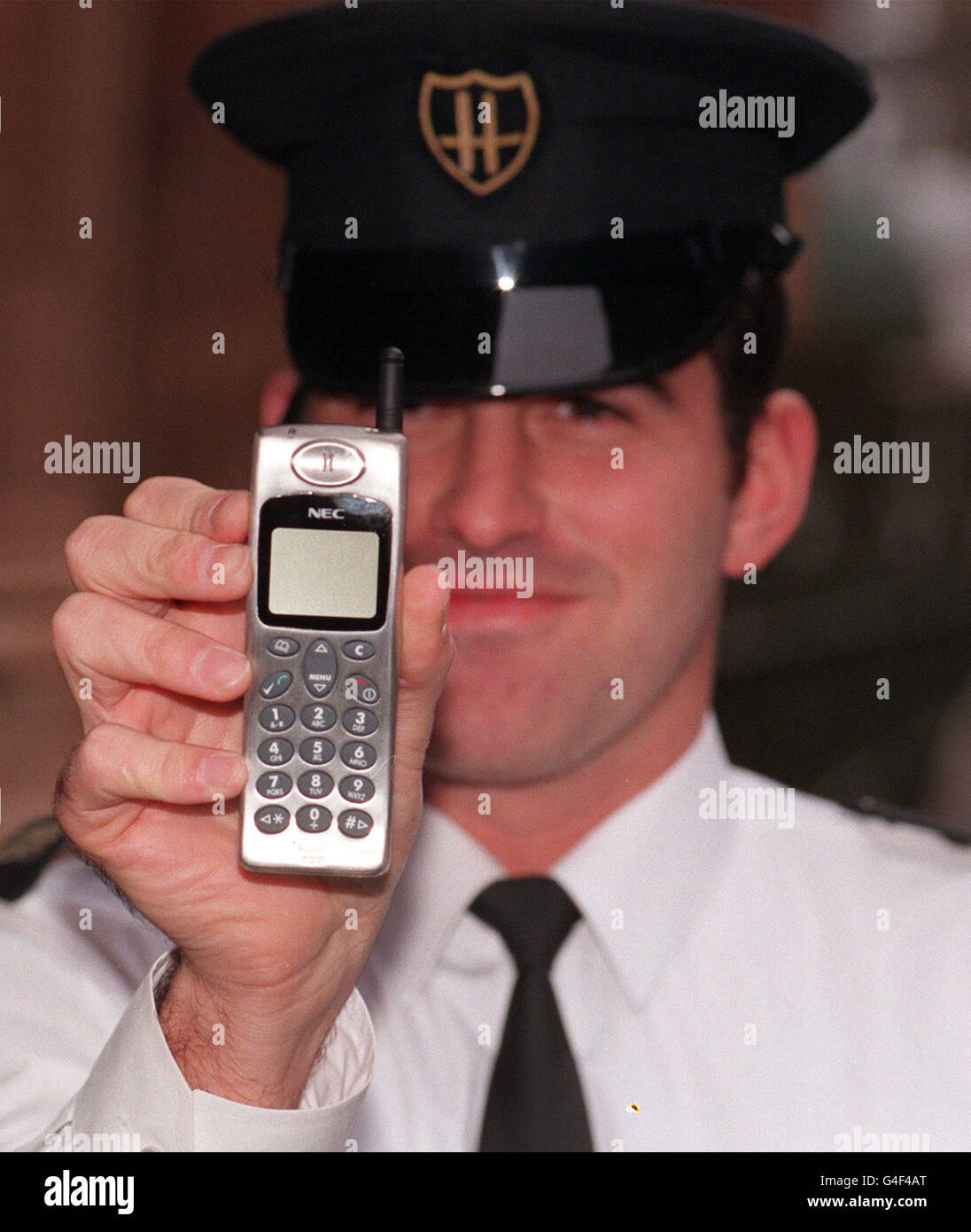 An unidentified security guard holds the world's first platinum phone ...