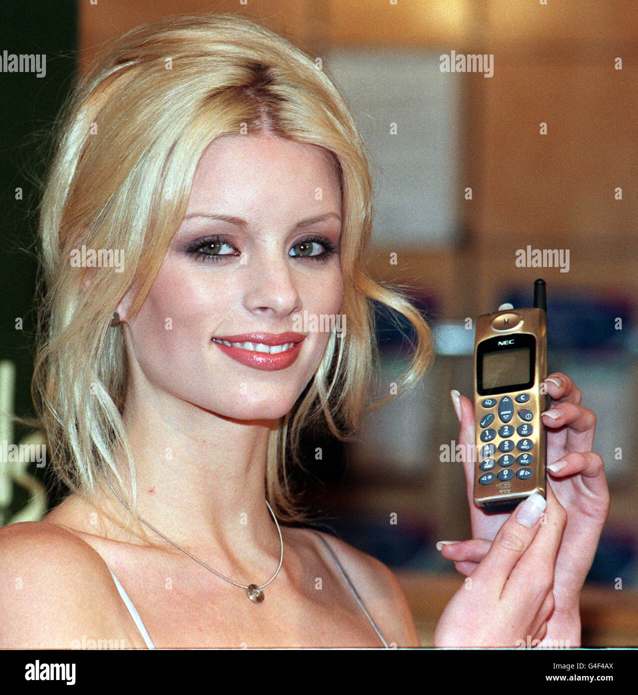 Model Emma B poses with the world's first platinum phone from NEC ...