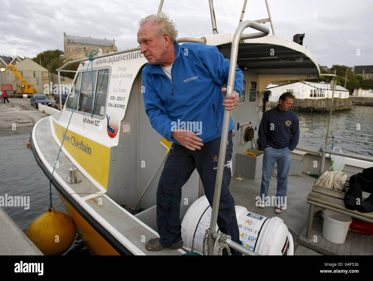 George David, skipper and owner of the Rambler 100, alights from a boat ...