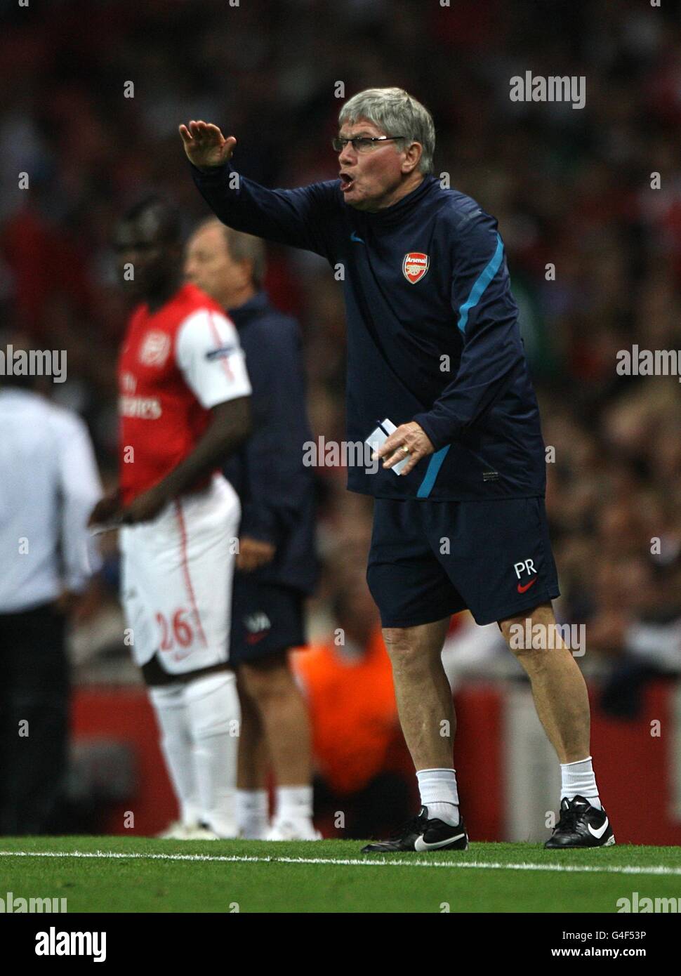 Arsenal assistant manager Pat Rice (right) directs the players from the ...