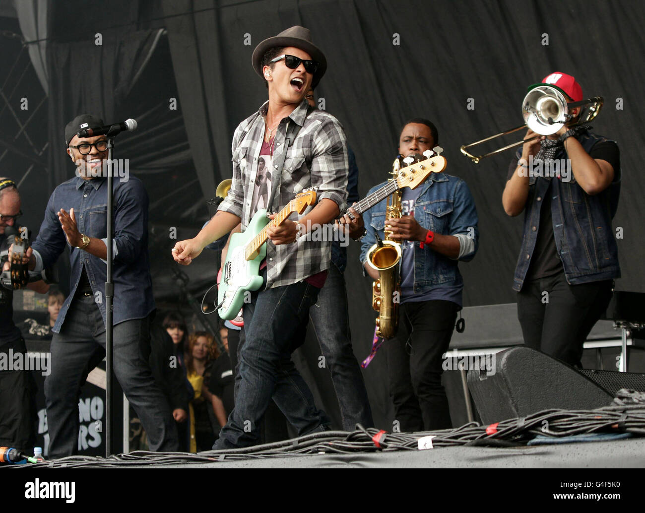 Bruno Mars (centre left) performs on the V Stage at V Festival 2011 in ...