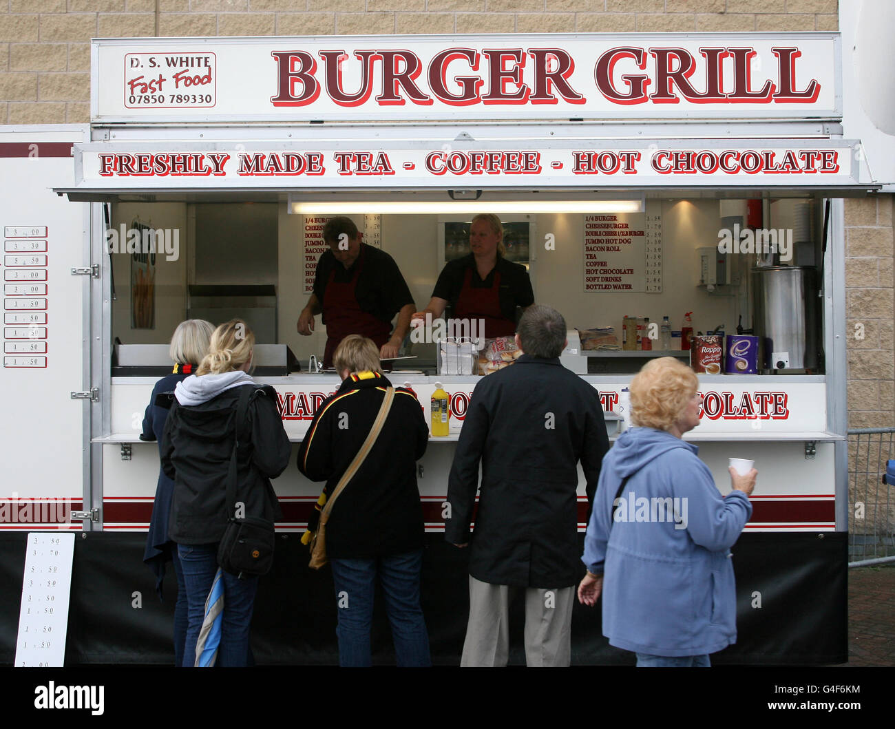 Football fans at a takeaway burger stand outside the ground Stock Photo ...