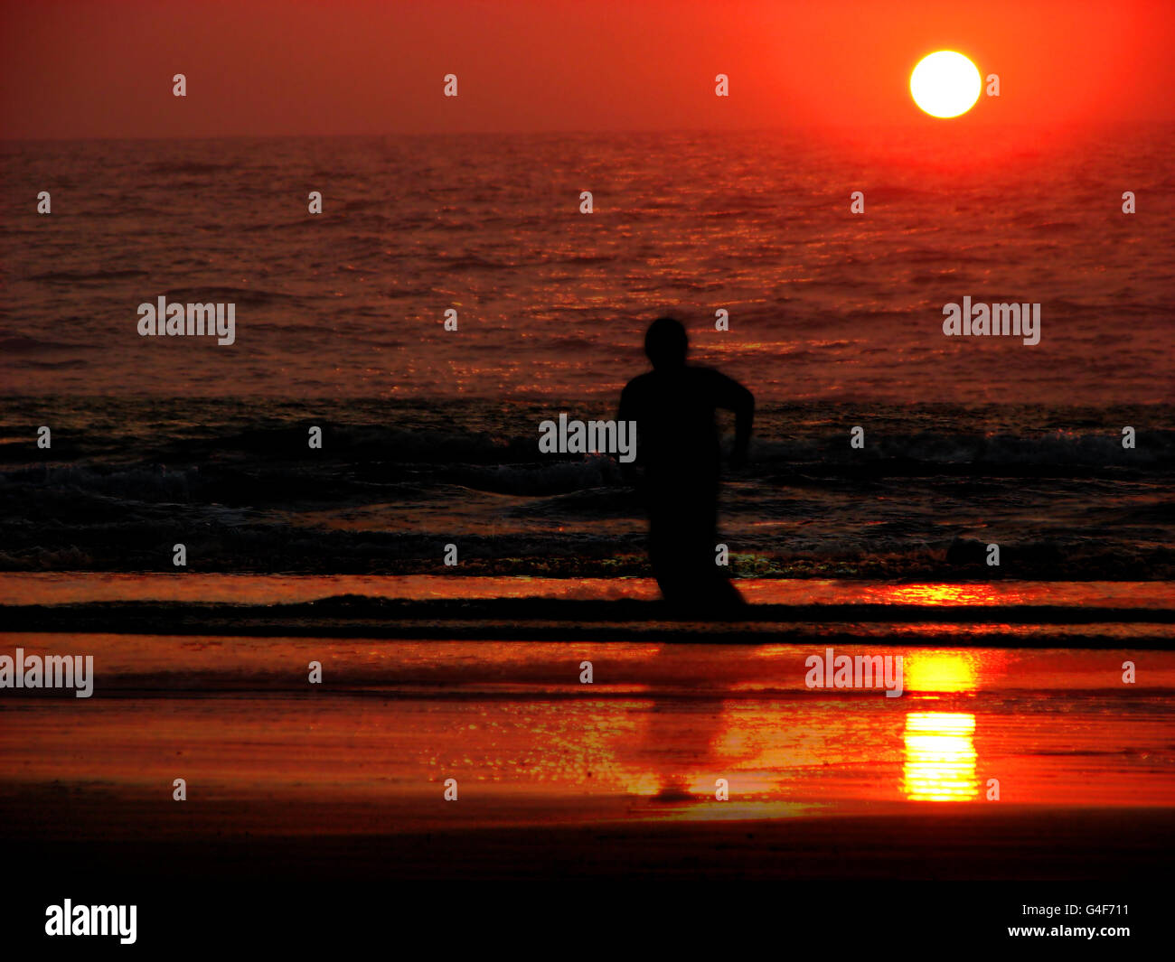 Running in the waves Stock Photo - Alamy