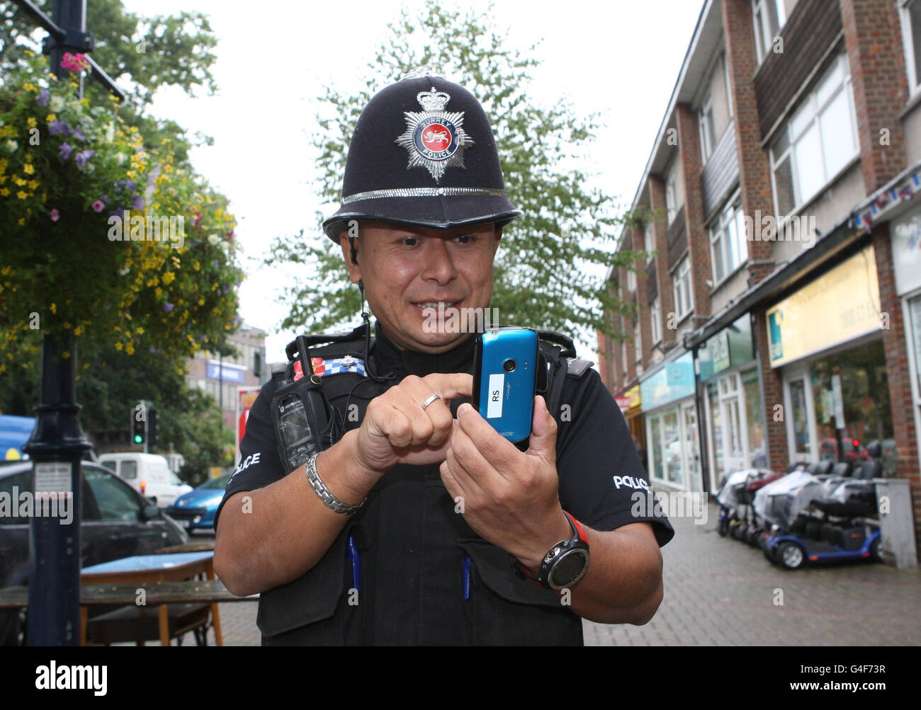 PC Rabin Shreztha uses the new Surrey Police mobile app in Runnymede ...