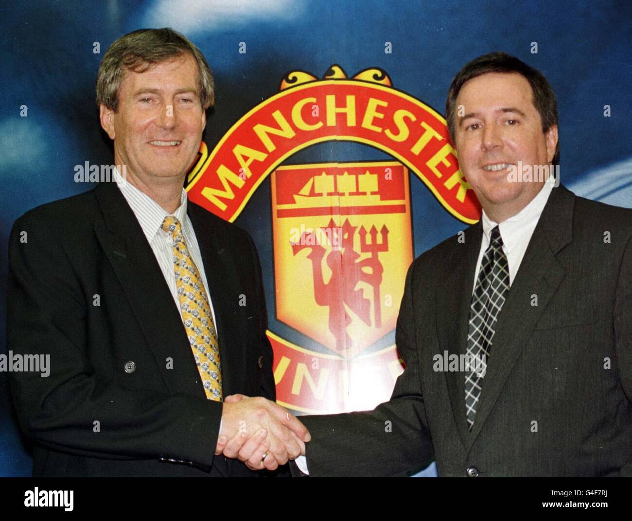 Martin Edwards, Chief Executive of Manchester United (left), shakes ...