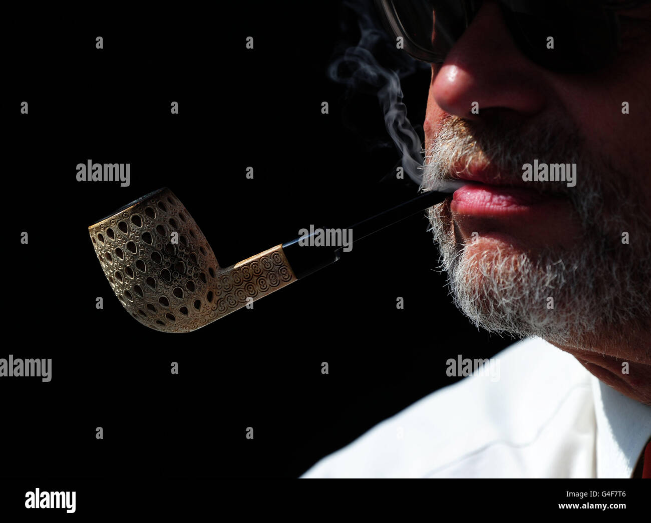 A member of the MCC at Lords enjoys smoking a pipe before the start of ...