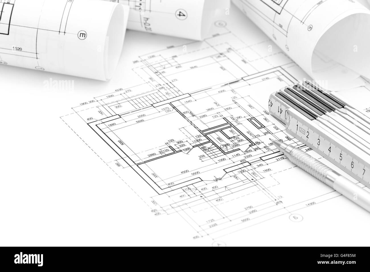 architectural project with rolled blueprints and technical drawings ...