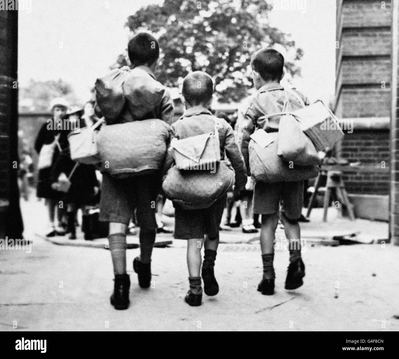 London schoolboys, complete with gas masks in cardboard boxes and ...