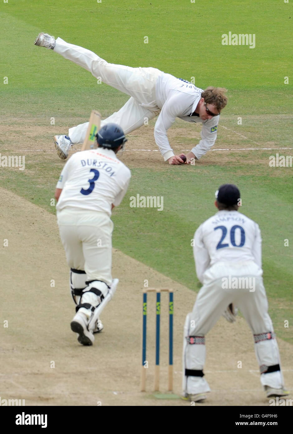 Middlesex's Jamie Dalrymple dives to stop a shot from Derbyshire's Wes ...