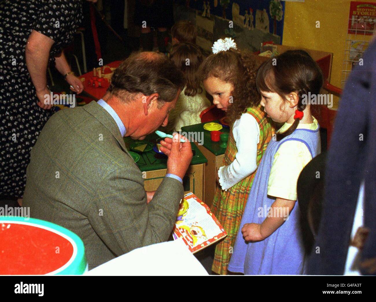 The Prince of Wales tries some sweets with toddlers (left to right ...