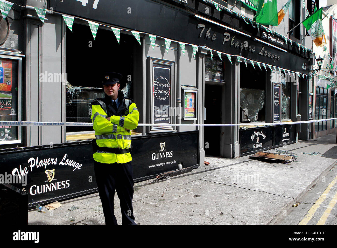 A police officer stands outside of the Players Lounge Pub in Fairview ...