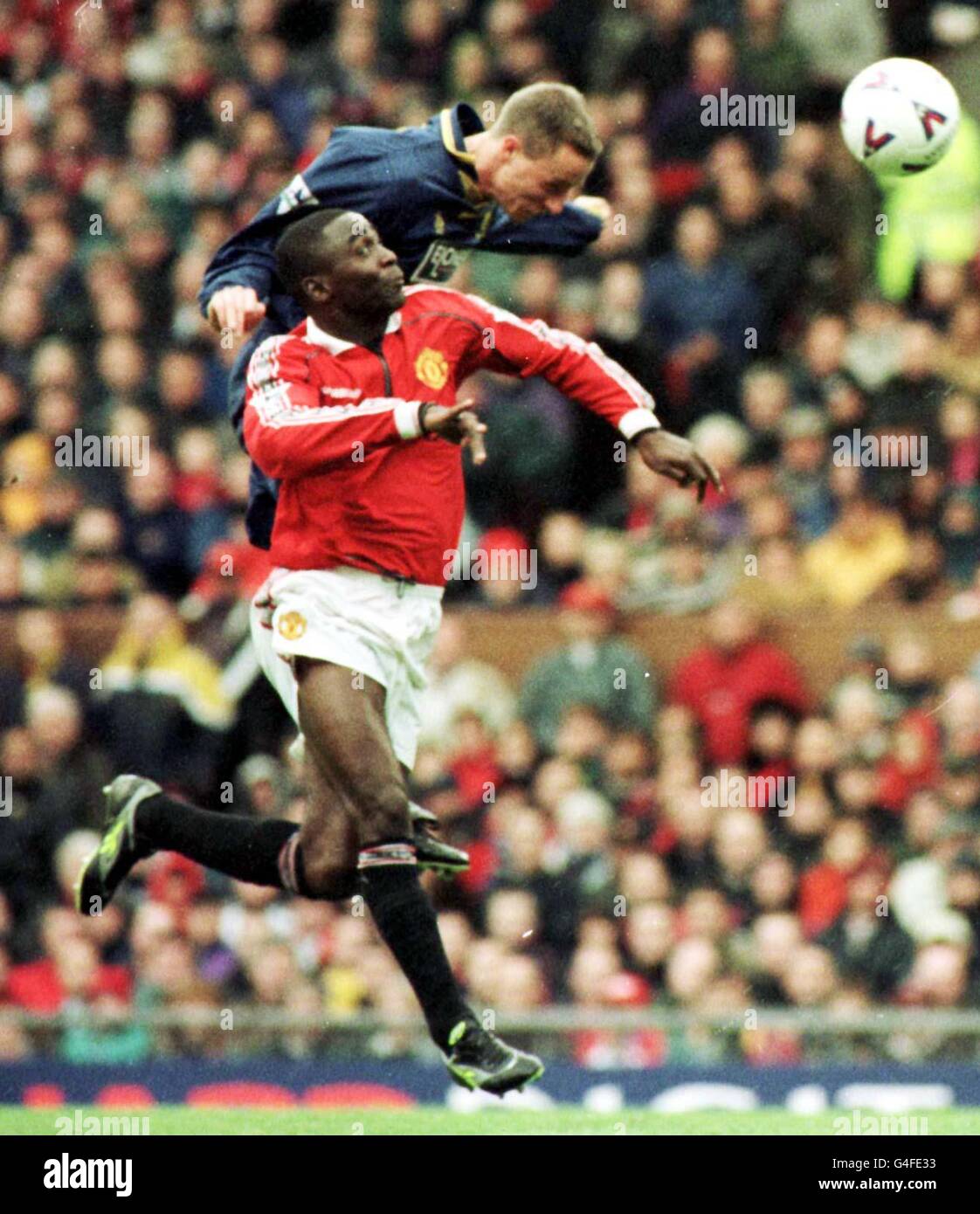 Wimbledon's Chris Perry beats Manchester United's Andy Cole to a header ...