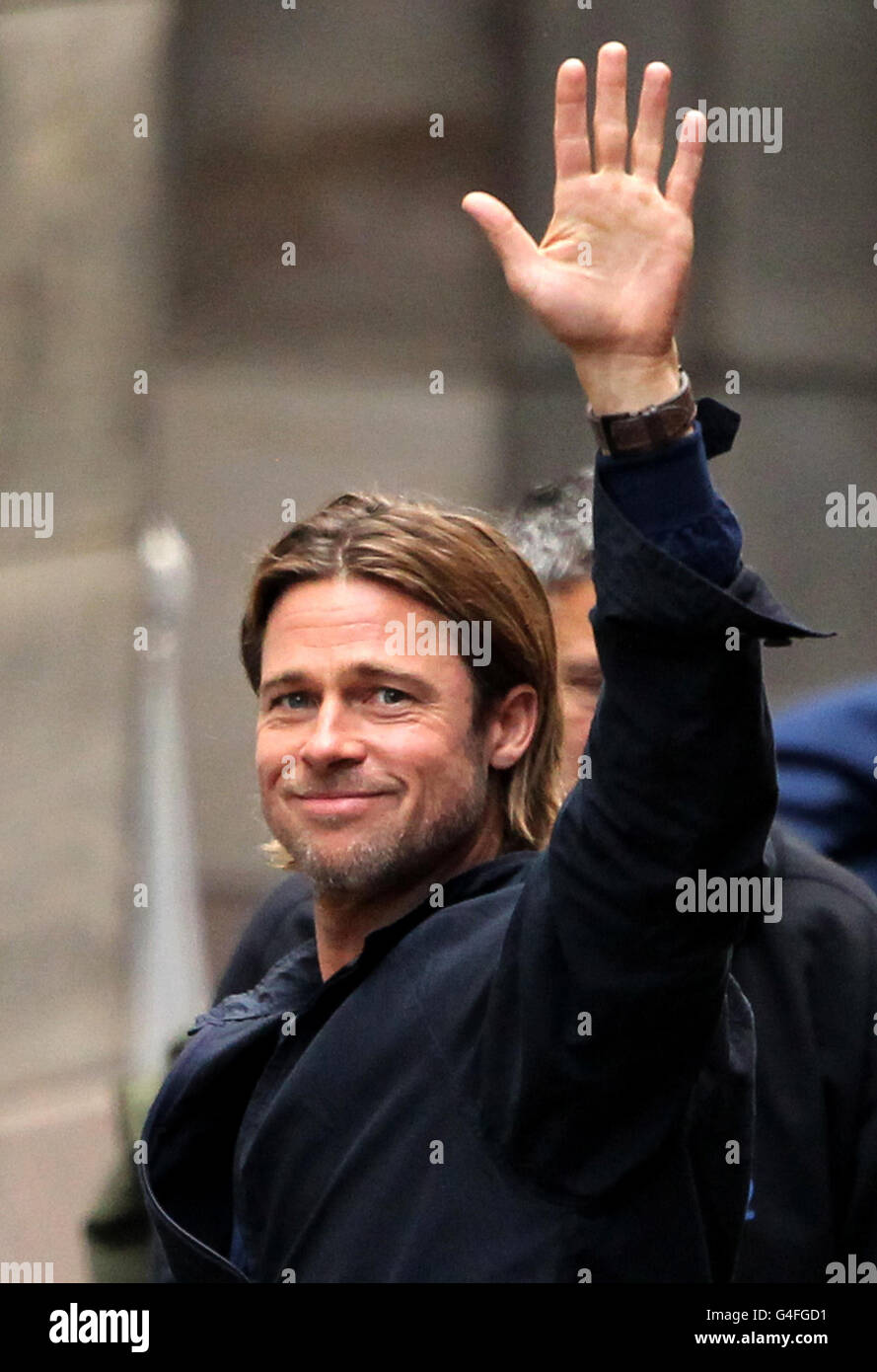 Brad Pitt waves as he leaves the set of World War Z near George Square ...