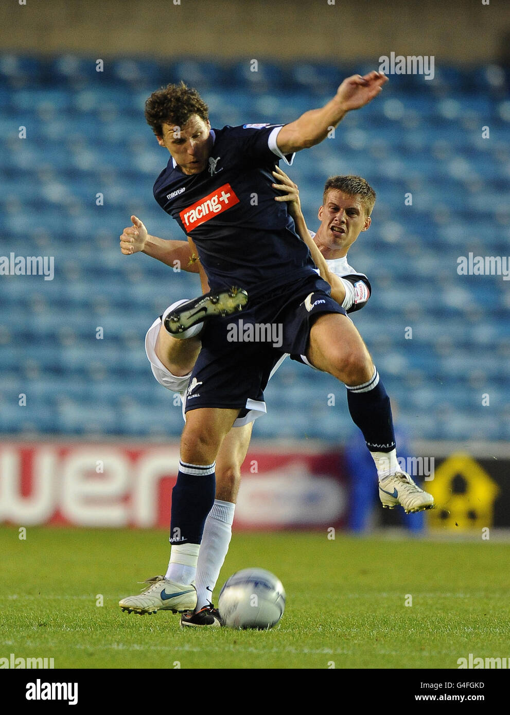 Millwall's Darius Henderson and Peterborough United's Ryan Bennett ...