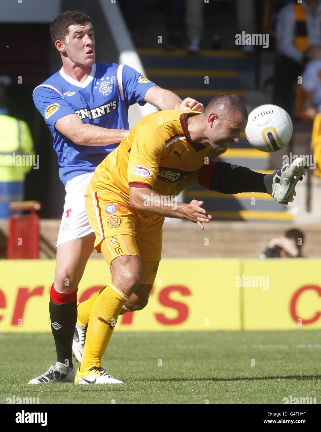 Rangers' Ross Perry (left) and Motherwell's Michael Higdon in action ...