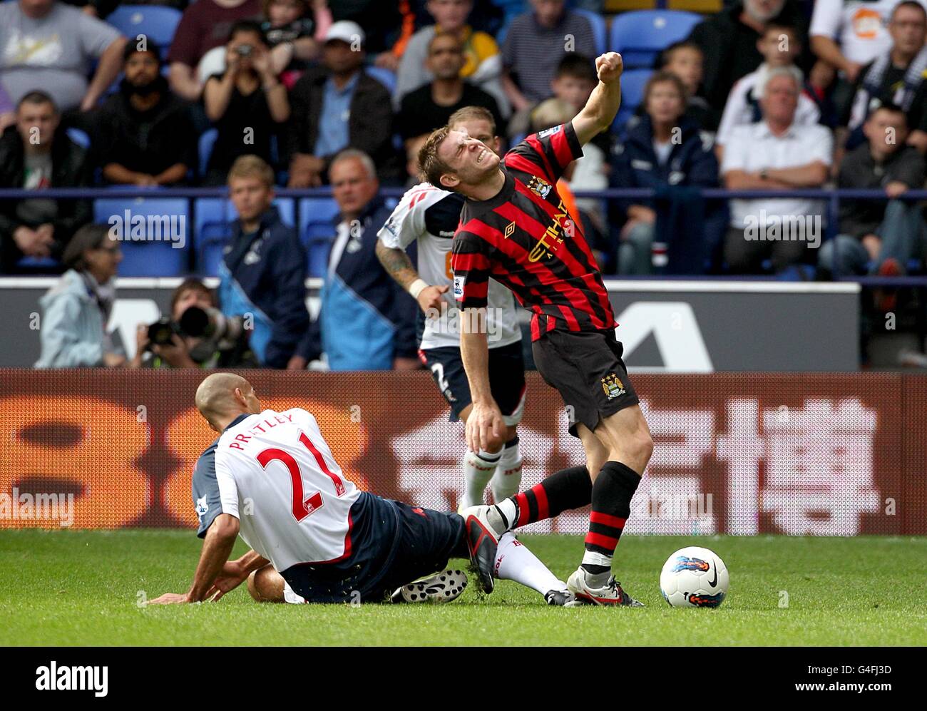 Bolton Wanderers' Darren Pratley (left) challenges Manchester City's ...