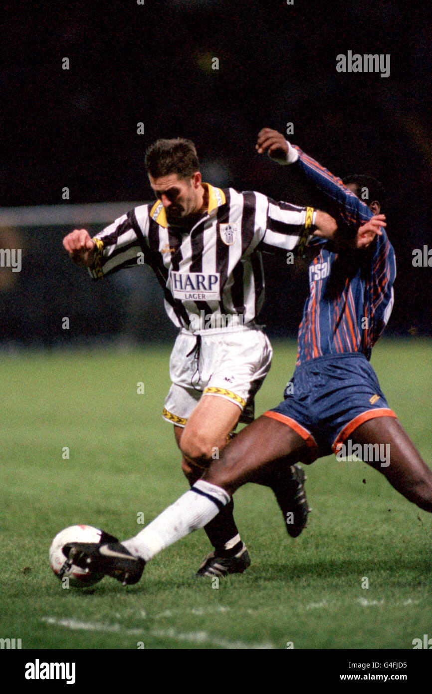 Luton Town's Mitchell Thomas tries to tackle Notts County's Gary Mills ...