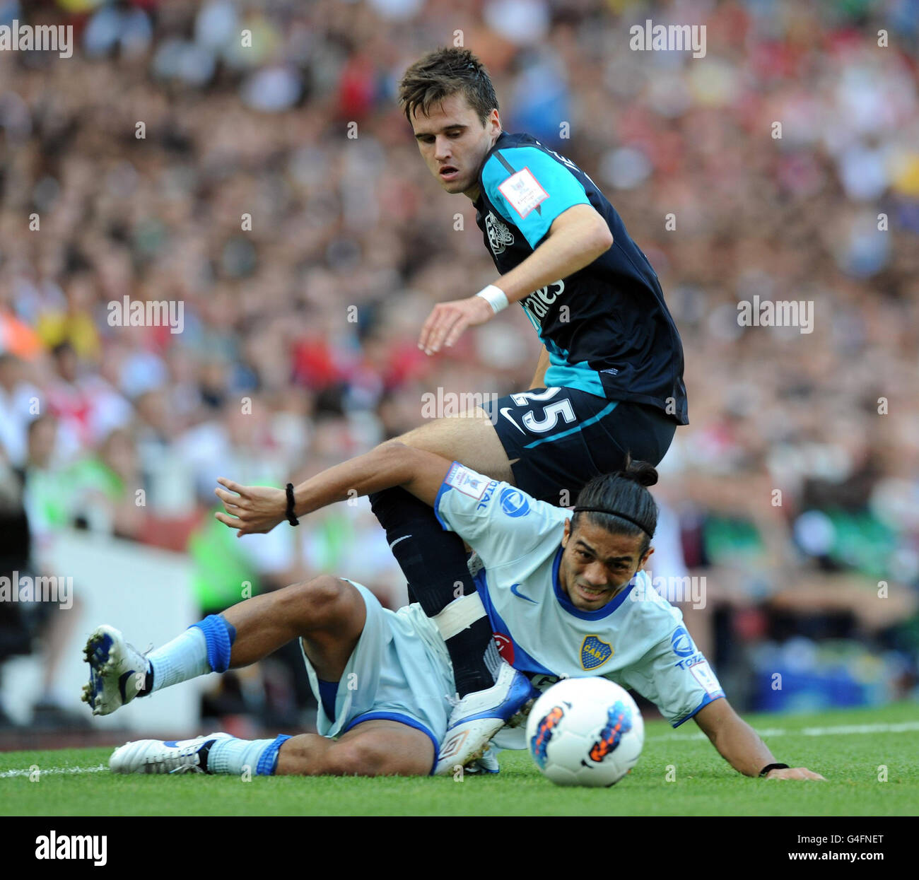Arsenal's Carl Jenkinson and and Boca Juniors' Walter Erviti (bottom ...