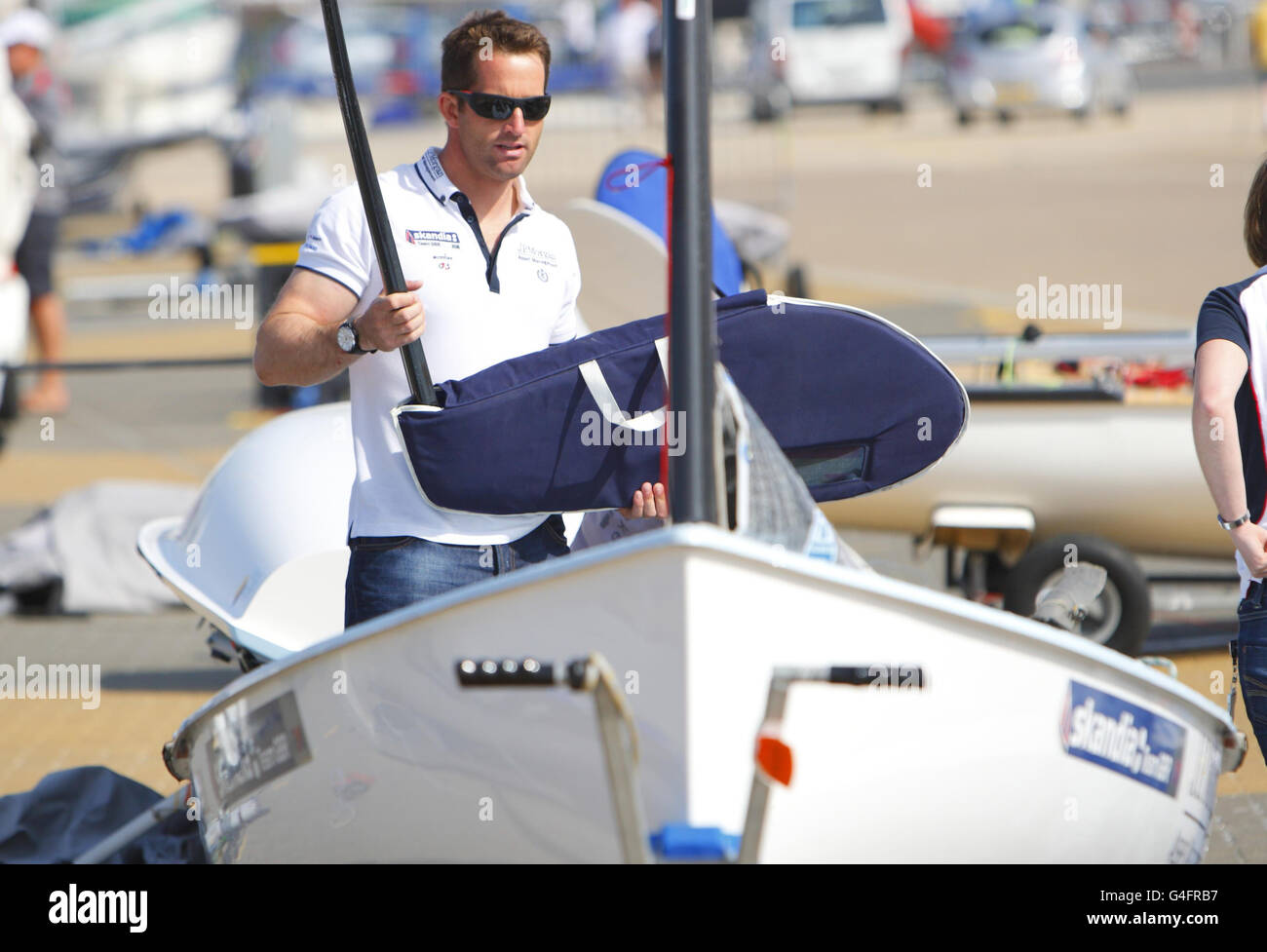 British Finn sailor Ben Ainslie prepares his dingy at the Weymouth and ...