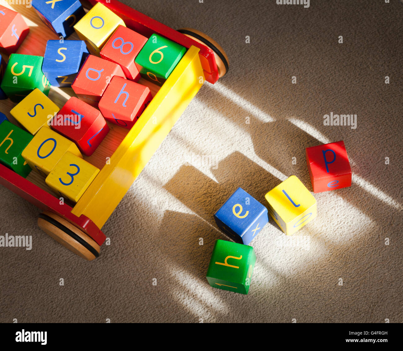 Children's wooden blocks spelling out "help Stock Photo - Alamy