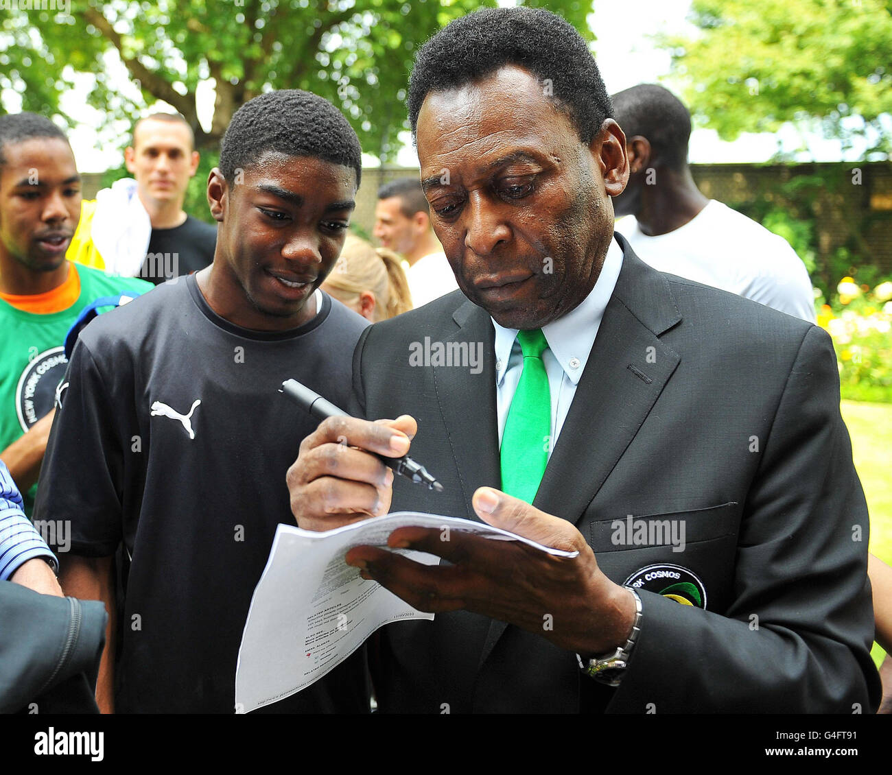 Former Brazilian footballer Pele signs autographs for young people from ...