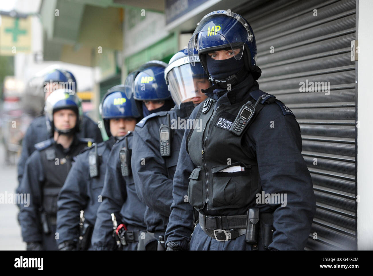 Metropolitan Police officers prepare to carry out a raid on a property ...