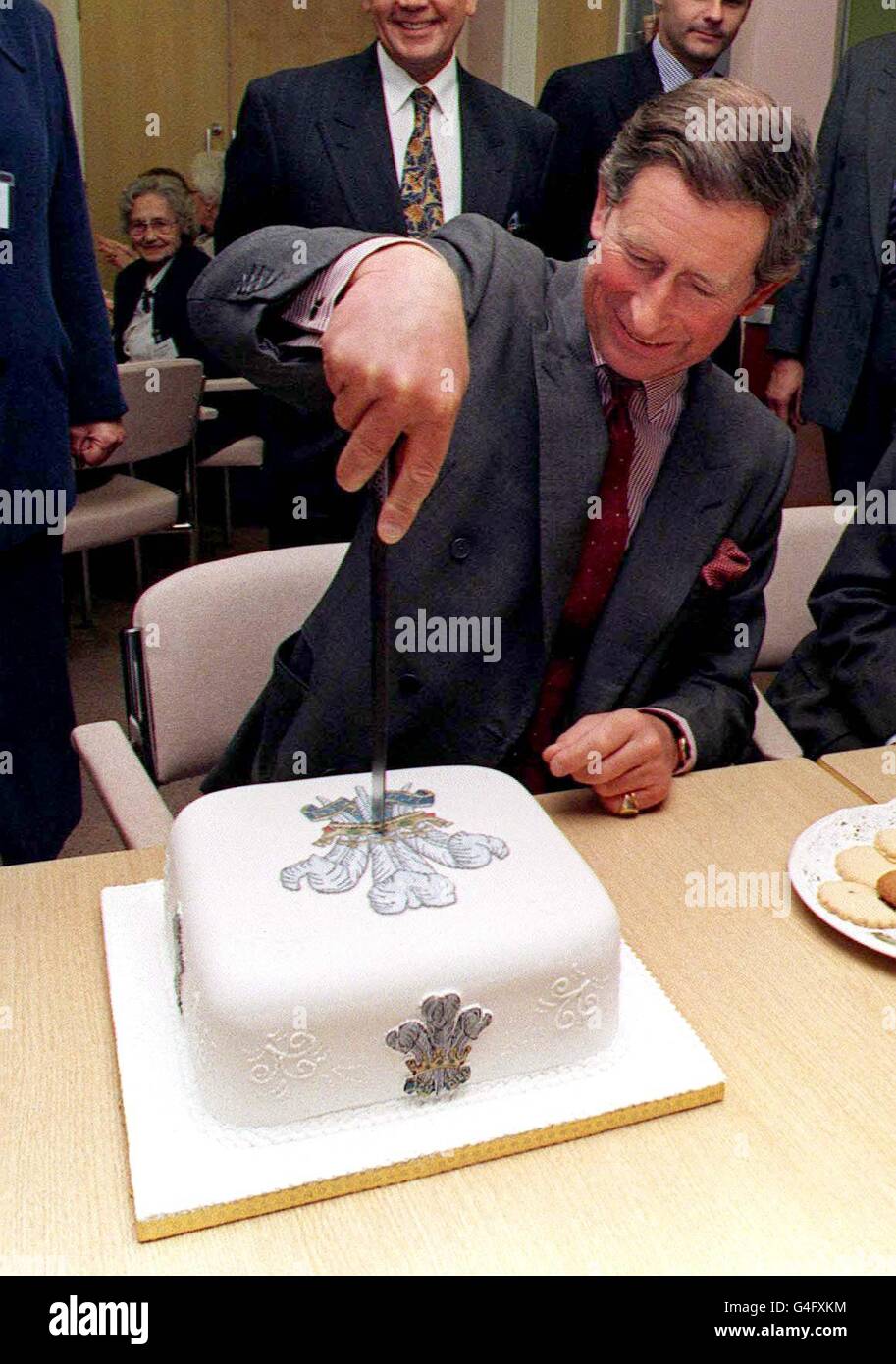 Early birthday cake for Prince Charles as he cuts the cake that was ...