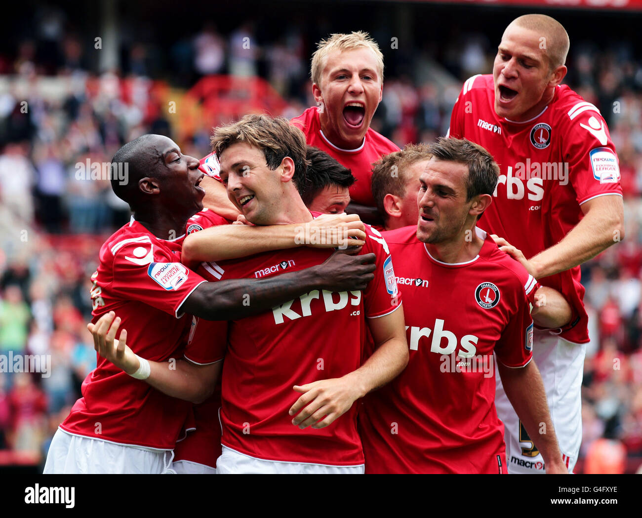 Charlton Athletic's Dale Stephens (front) is congratulated by his team ...