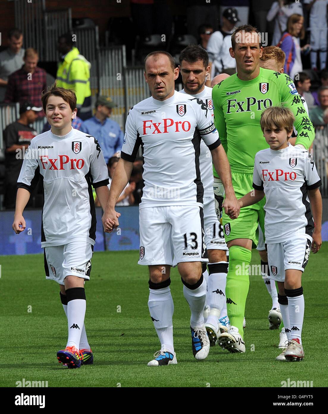 Fulham's Danny Murphy leads the team out with two mascots Stock Photo ...