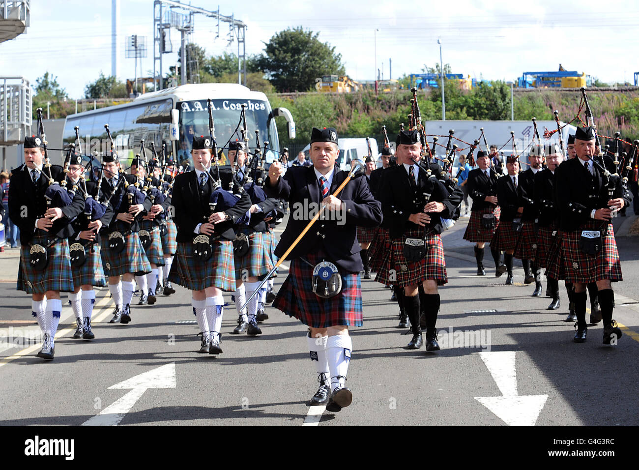 Bagpipe players outside pose with mascots outside Murrayfield prior to ...