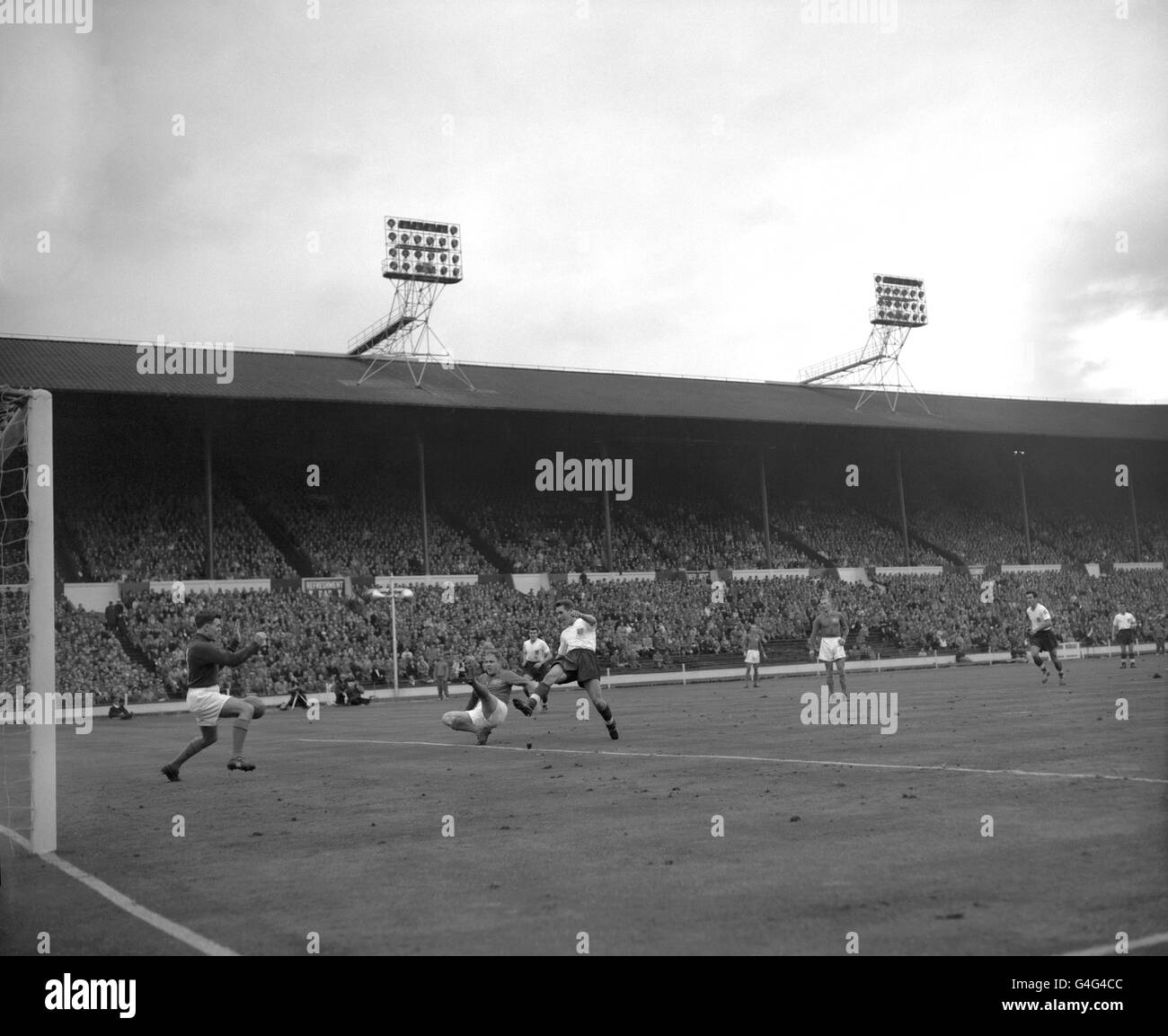 England centre forward Brian Clough shoots at the Swedish goal, only to ...
