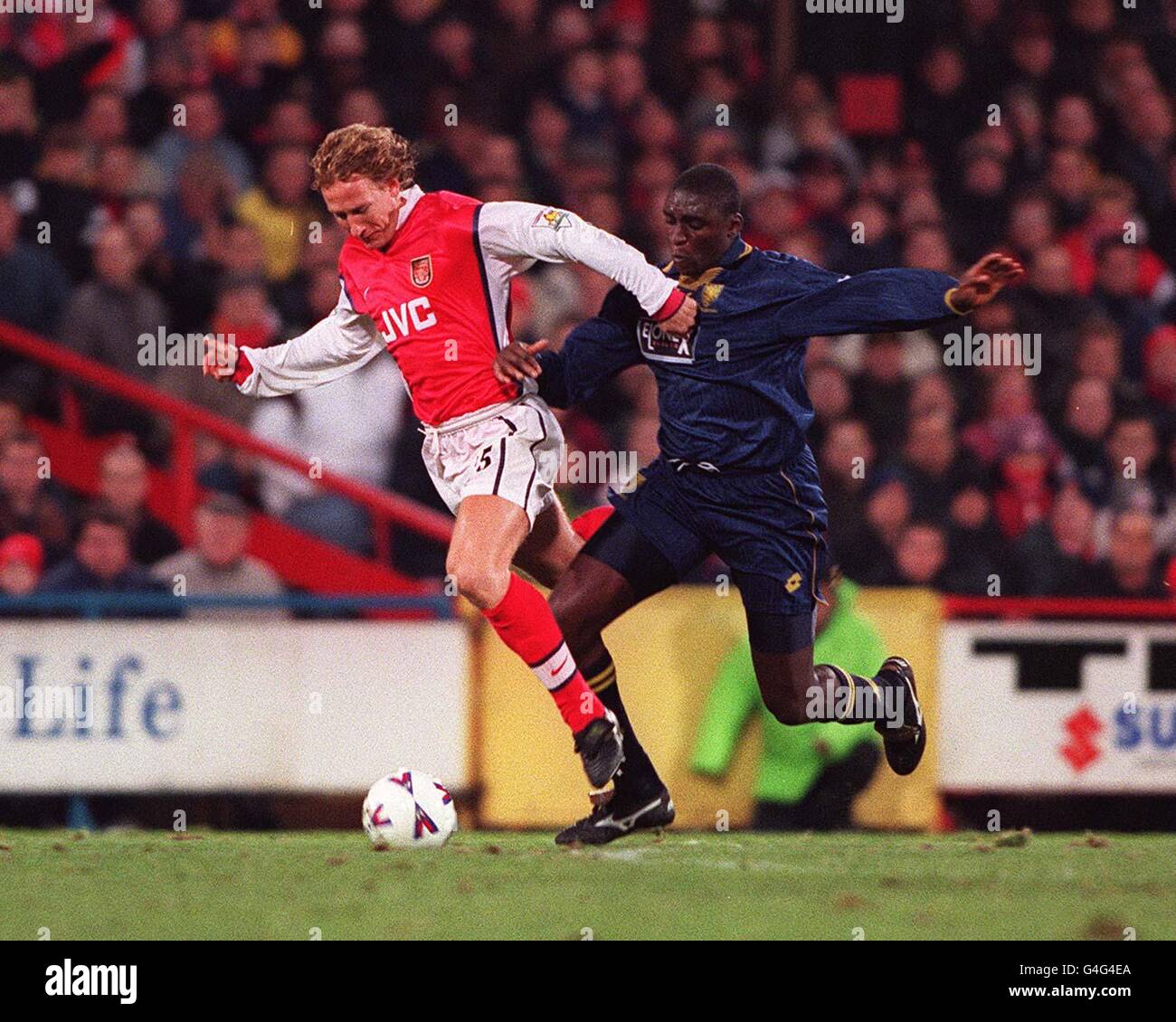 Arsenal's Ray Palour (left) takes on Wimbledon's Carl Leaburn t ...