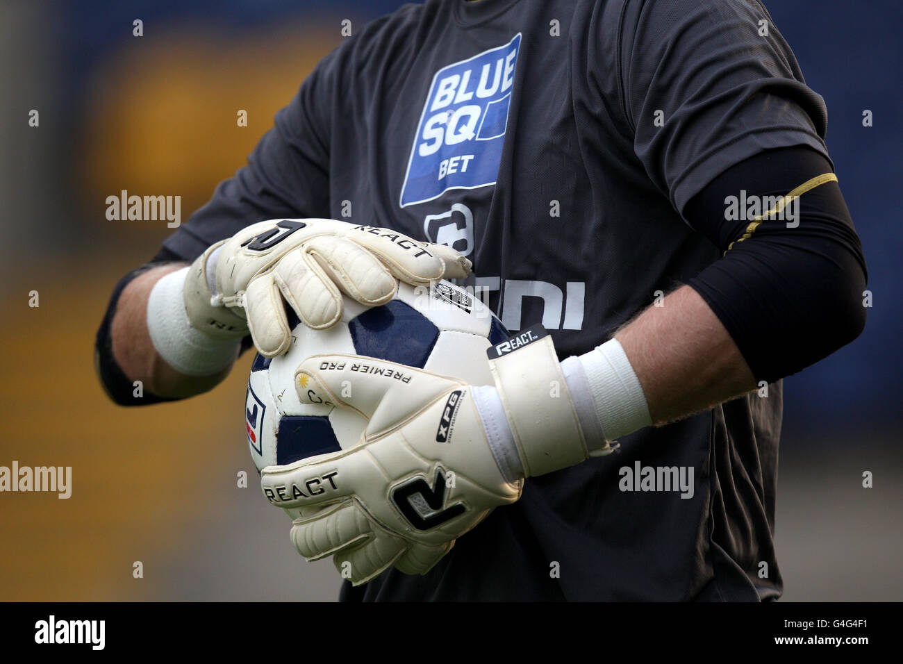 Detail of an official Blue Square Premier match ball being held against ...