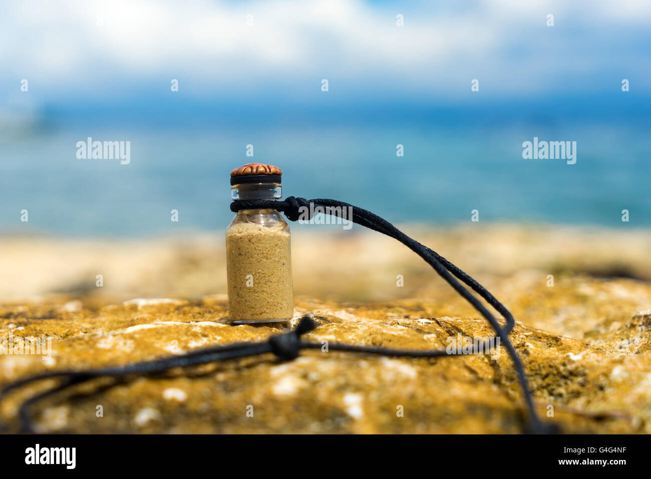 Vial with white sand like memory about tropical vacation. Sea and blue ...