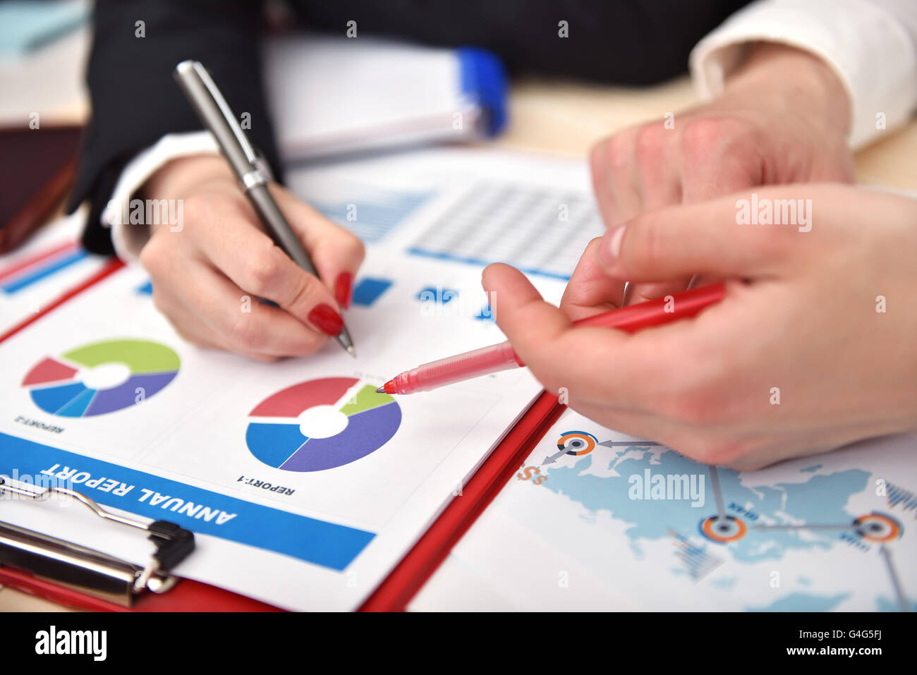 human hands analyzing the business diagrams on foreground Stock Photo ...