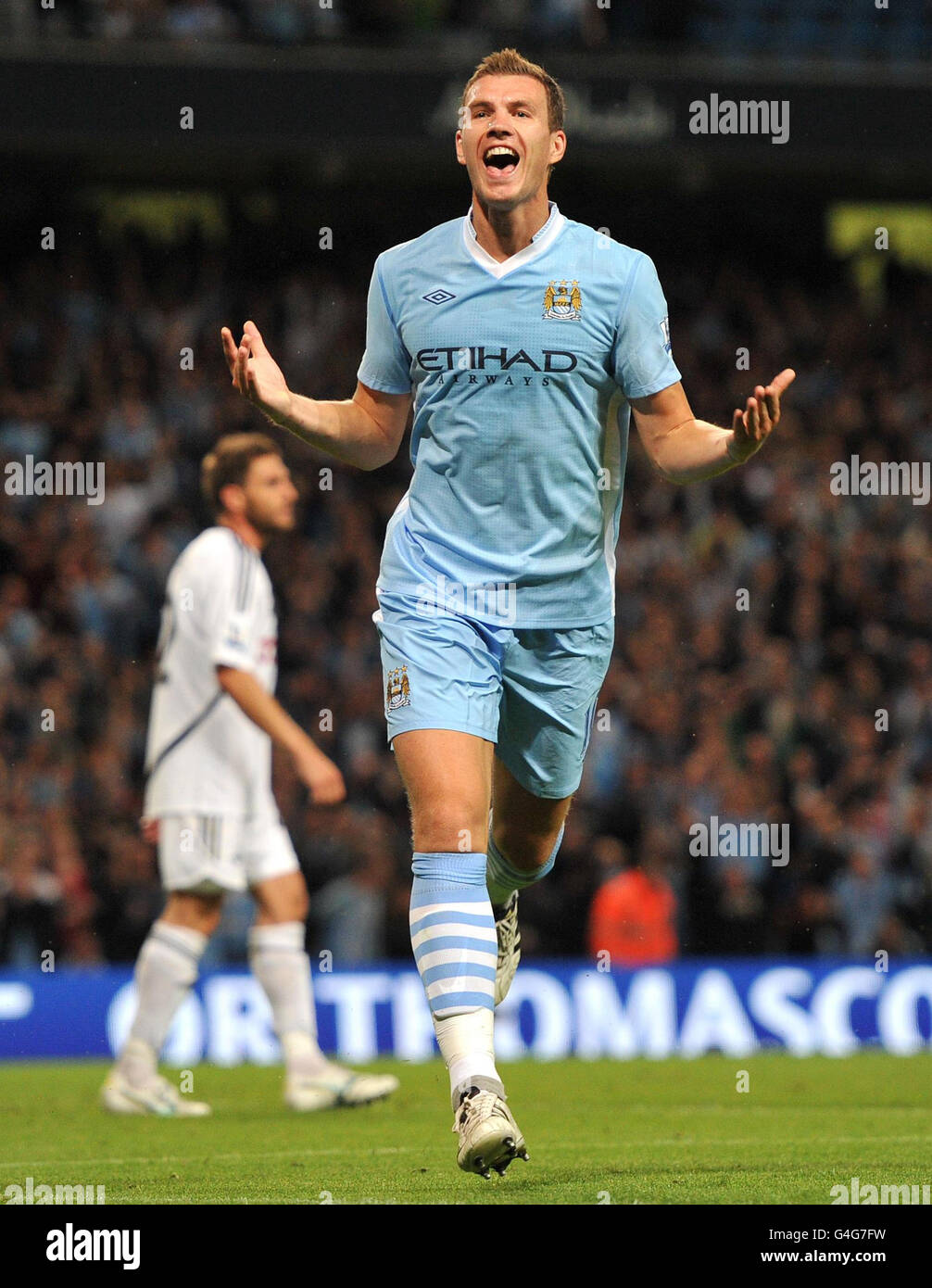 Manchester City's Edin Dzeko celebrates scoring the opening goal during ...