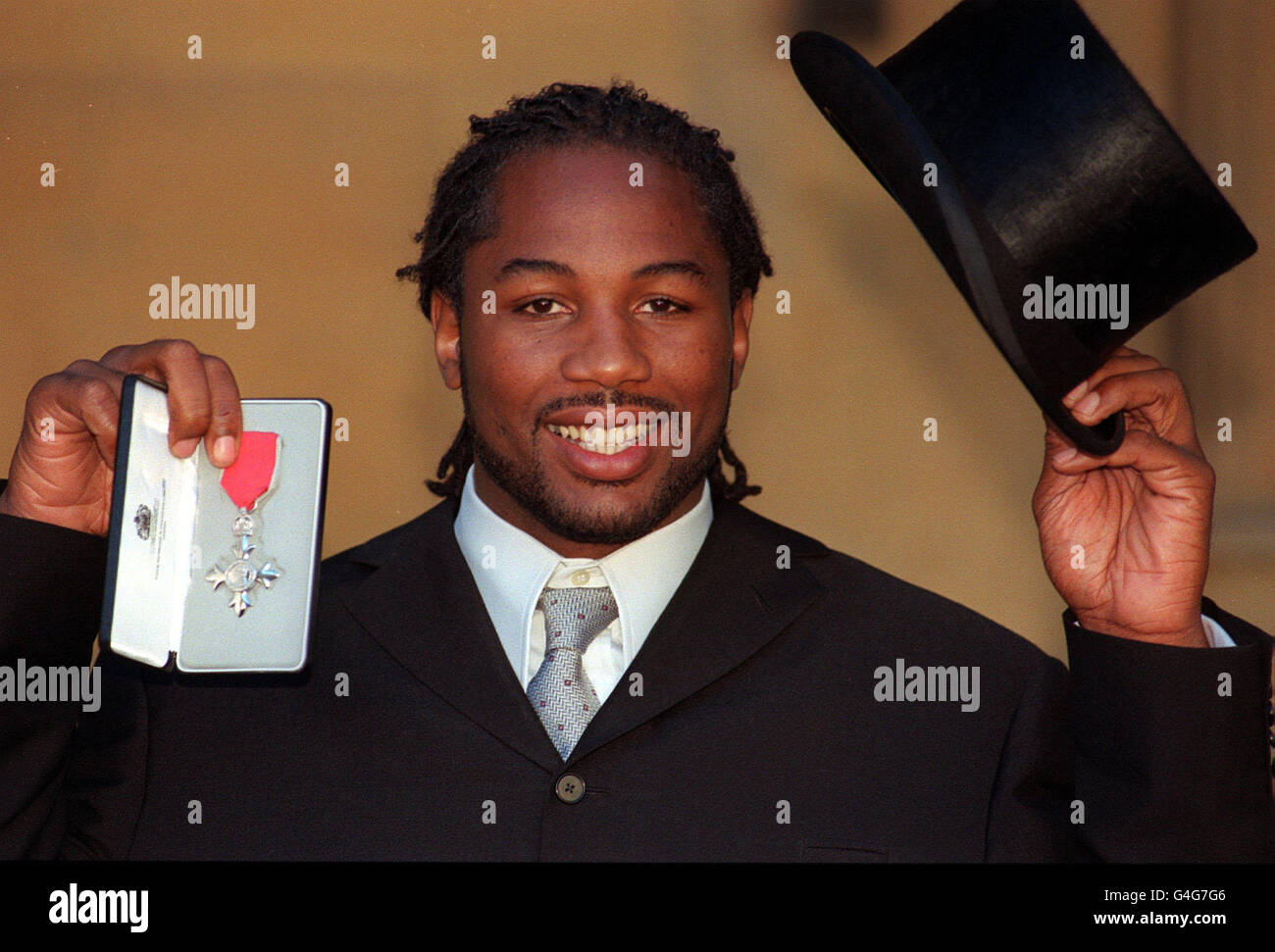 PA NEWS 30/10/98 WBC BOXING CHAMPION LENNOX LEWIS WITH HIS MBE OUTSIDE ...