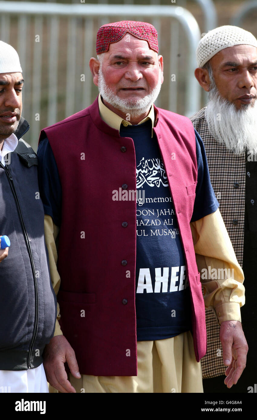 Ghazanfar Ali (in red cap) arrives for the funeral of his sons Shazad ...