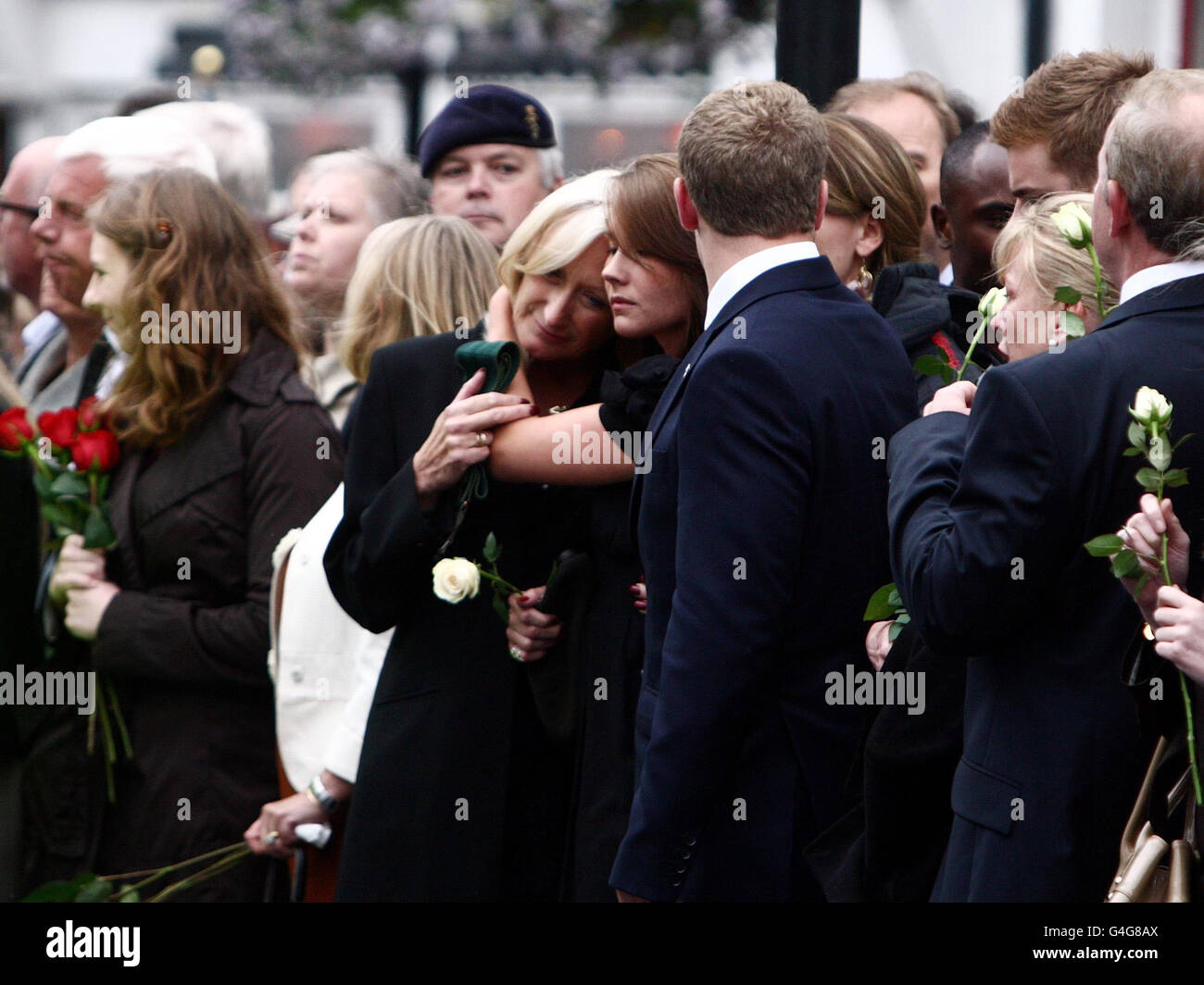 Lieutenant Daniel Clack's fiancee Amy Tinley (centre right) comforts ...