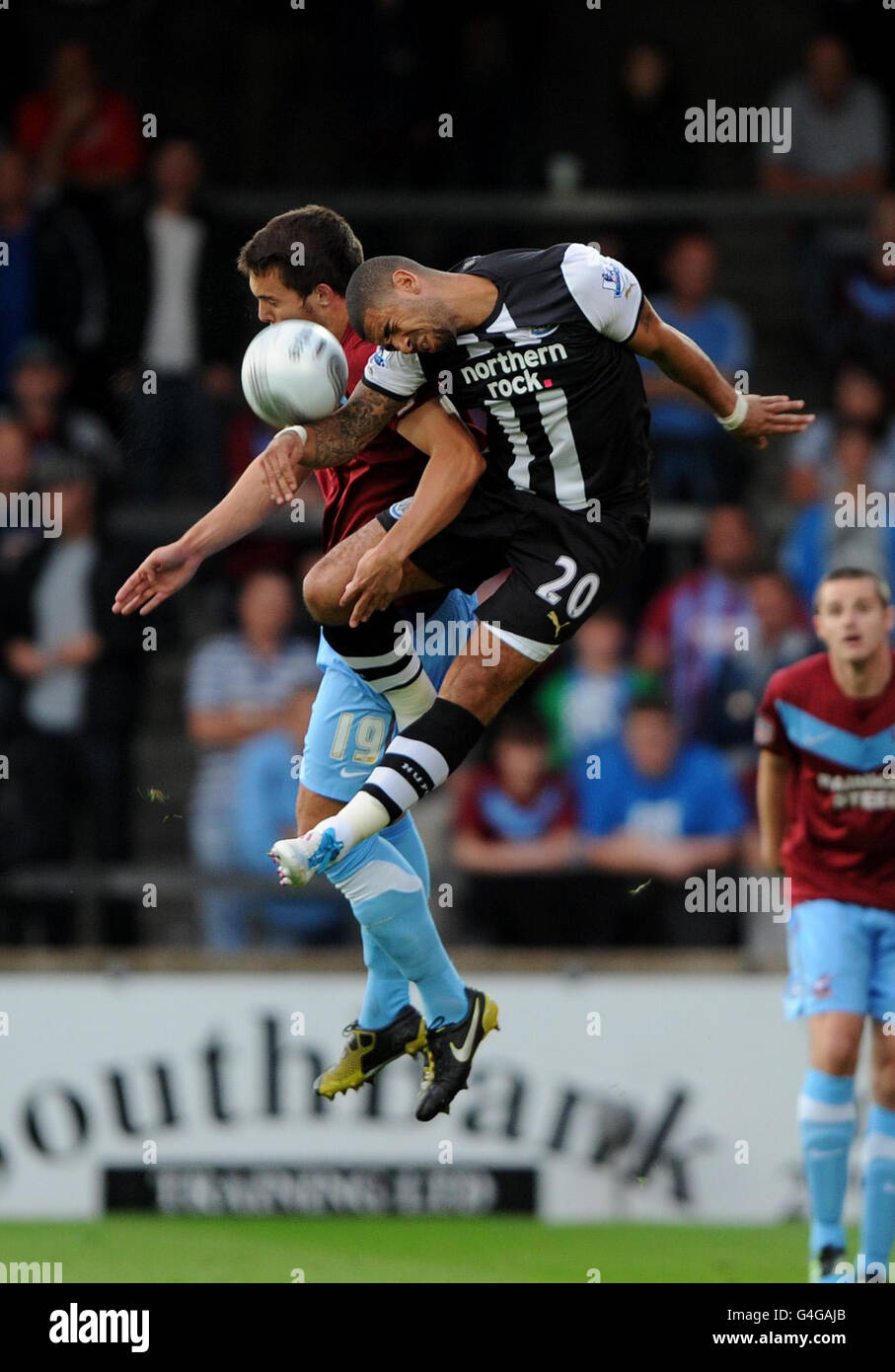 Scunthorpe United's Niall Canavan (left) jumps for the ball with ...