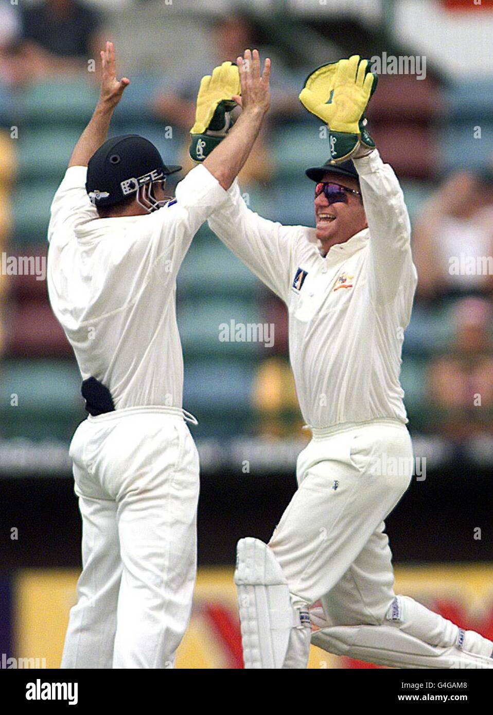 Australian wicket keeper Ian Healy (right) celebrates with Justin ...